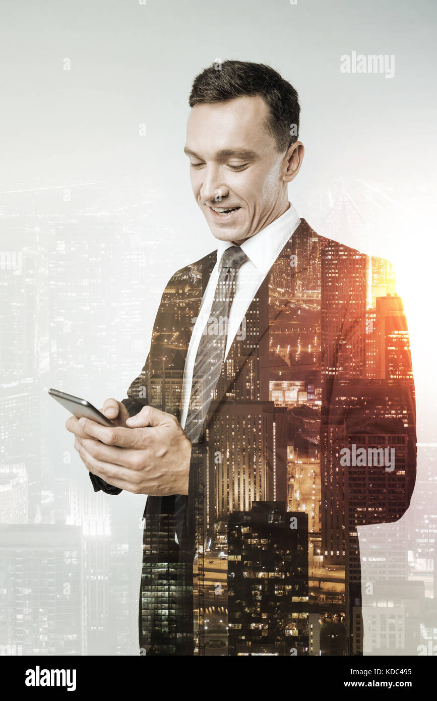 Elegant man looking concentrated while typing a message Stock Photo - Alamy