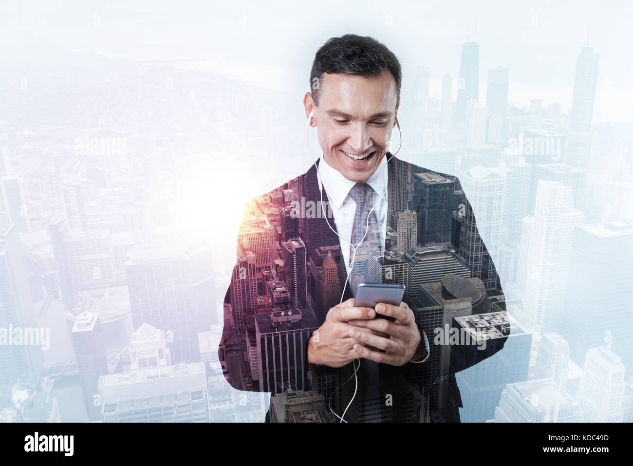 Elegant man listening to music in his earphones Stock Photo - Alamy