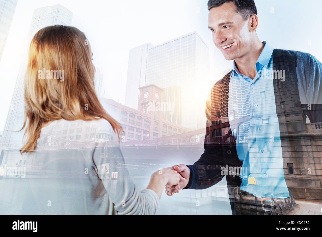Pleasant man getting acquainted with his new coworker Stock Photo - Alamy