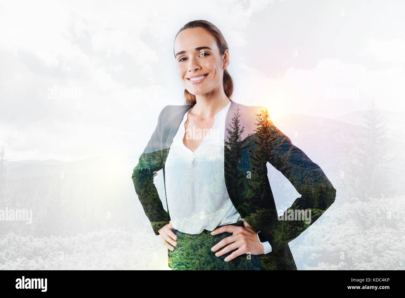 Inspiring cheerful manager standing and smiling Stock Photo - Alamy