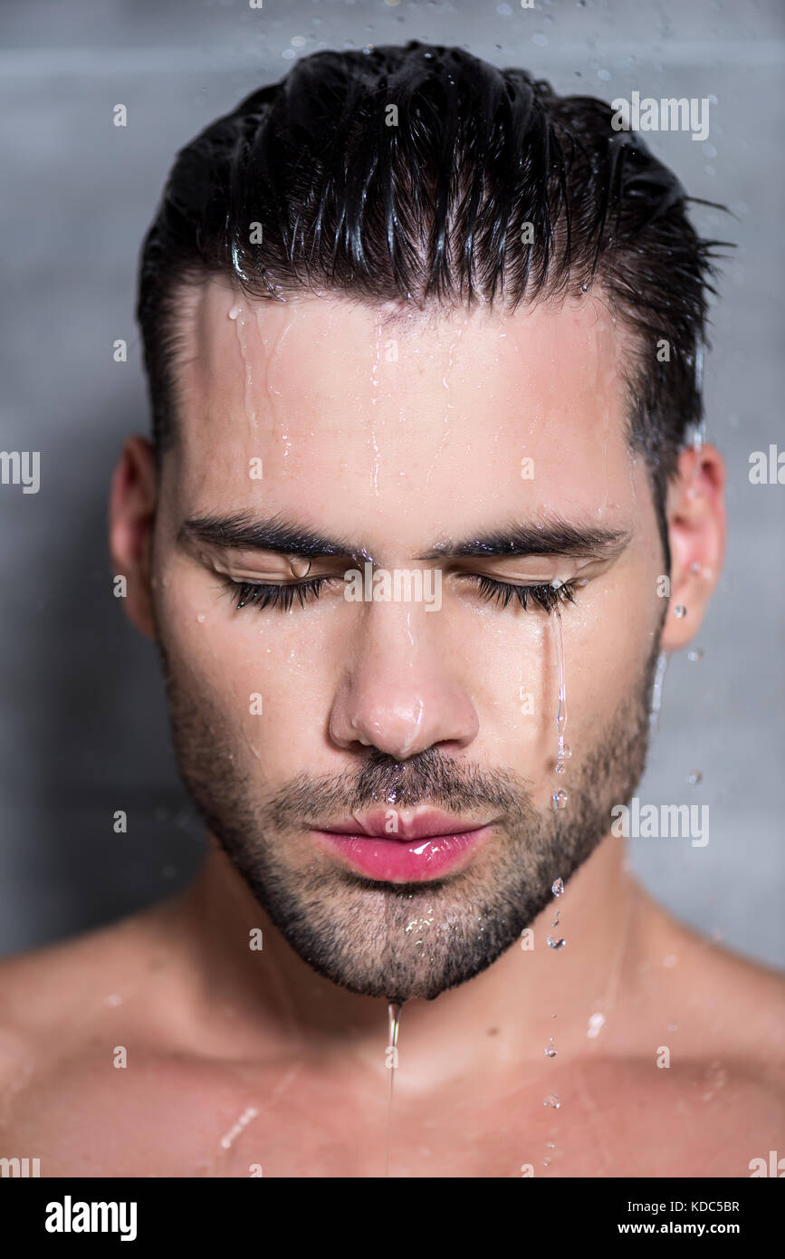 young man taking shower Stock Photo - Alamy