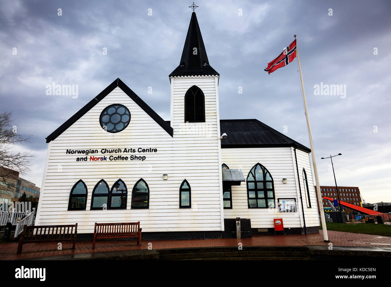 The Norwegian church Arts Centre with flag flying on a cold and wet ...
