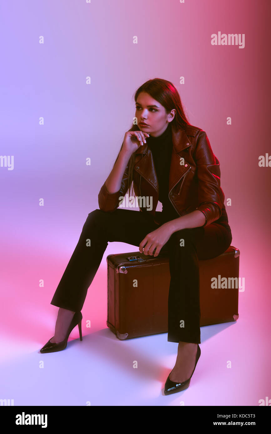 model sitting on suitcase Stock Photo - Alamy
