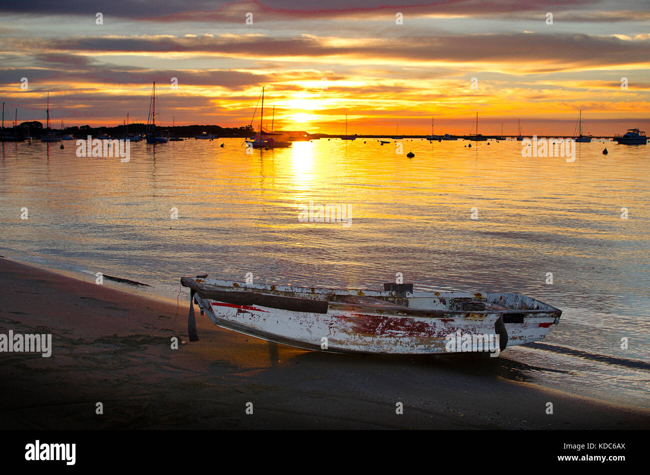 old dingy on beach at sunset Stock Photo - Alamy