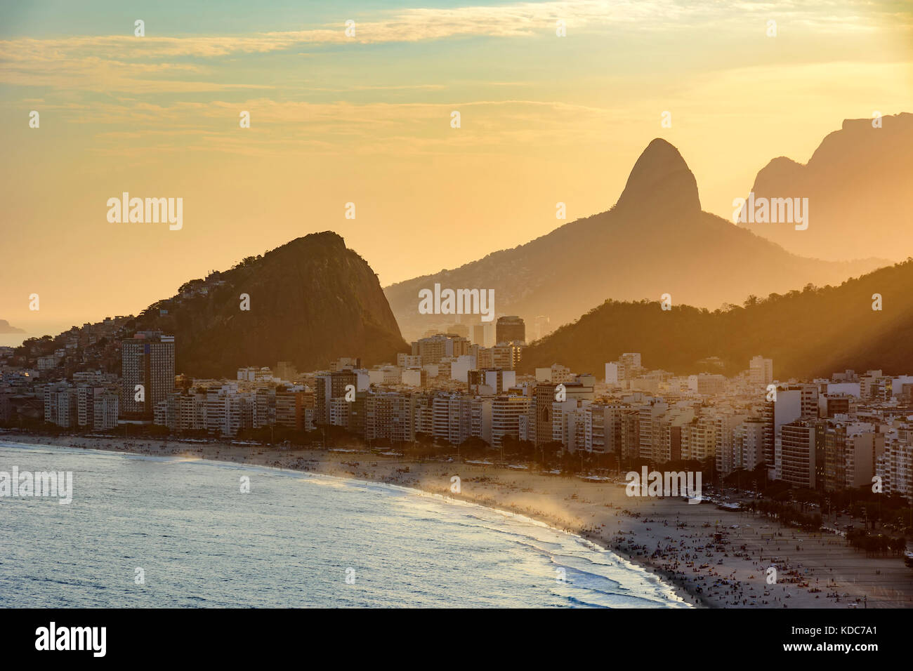 Golden sunset between Copacabana buildings and hills Stock Photo - Alamy
