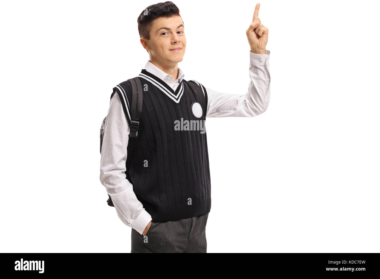 Teenage student pointing up with his finger isolated on white ...