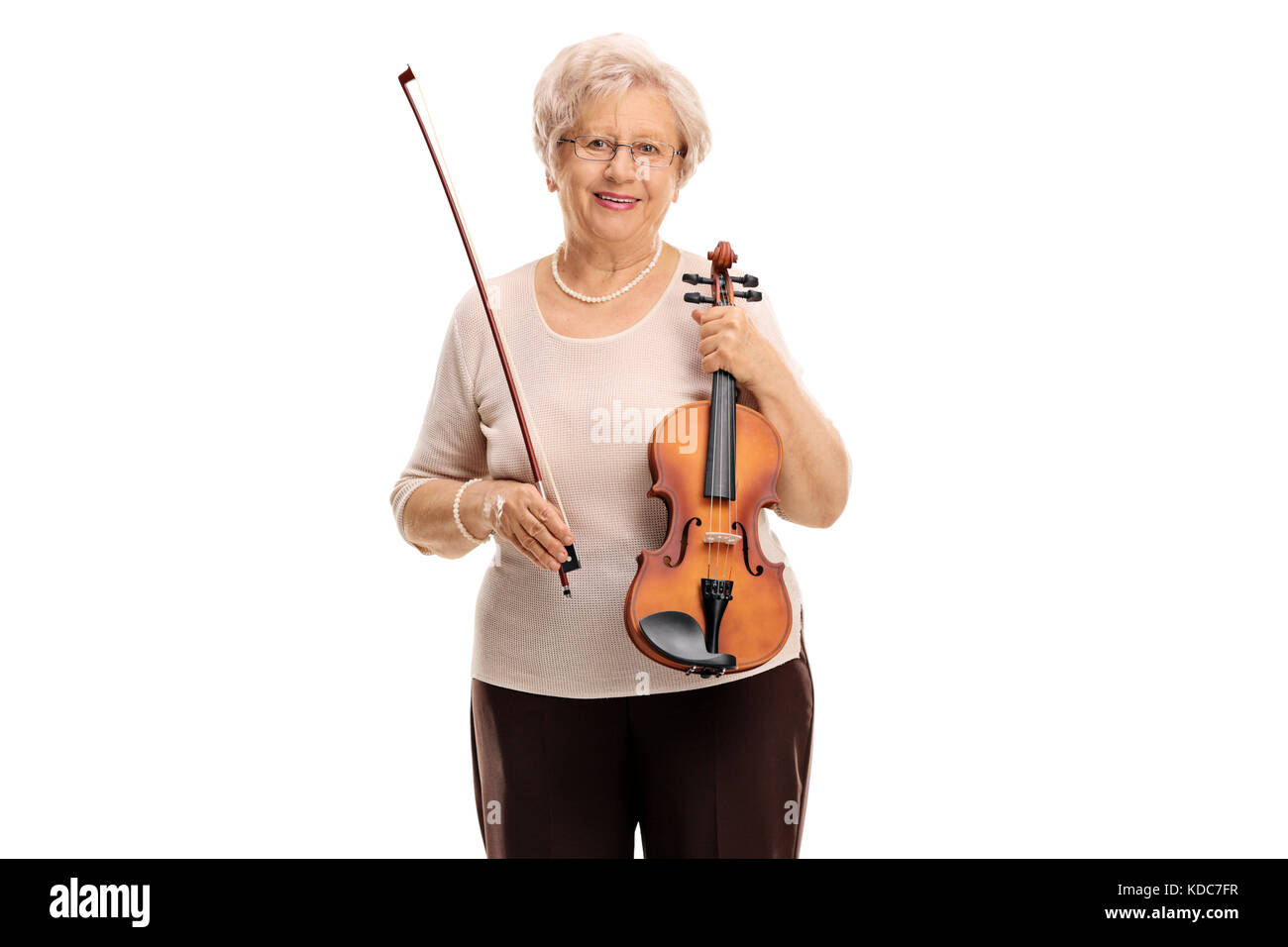 Mature woman with a wand and a violin isolated on white background ...