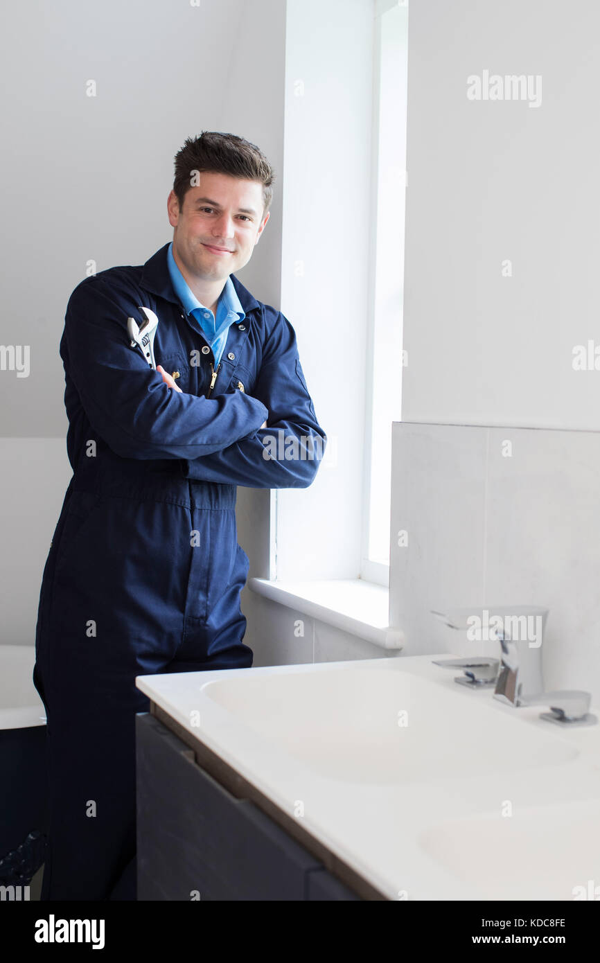 Portrait Of Plumber Standing By Sink In Bathroom Stock Photo - Alamy