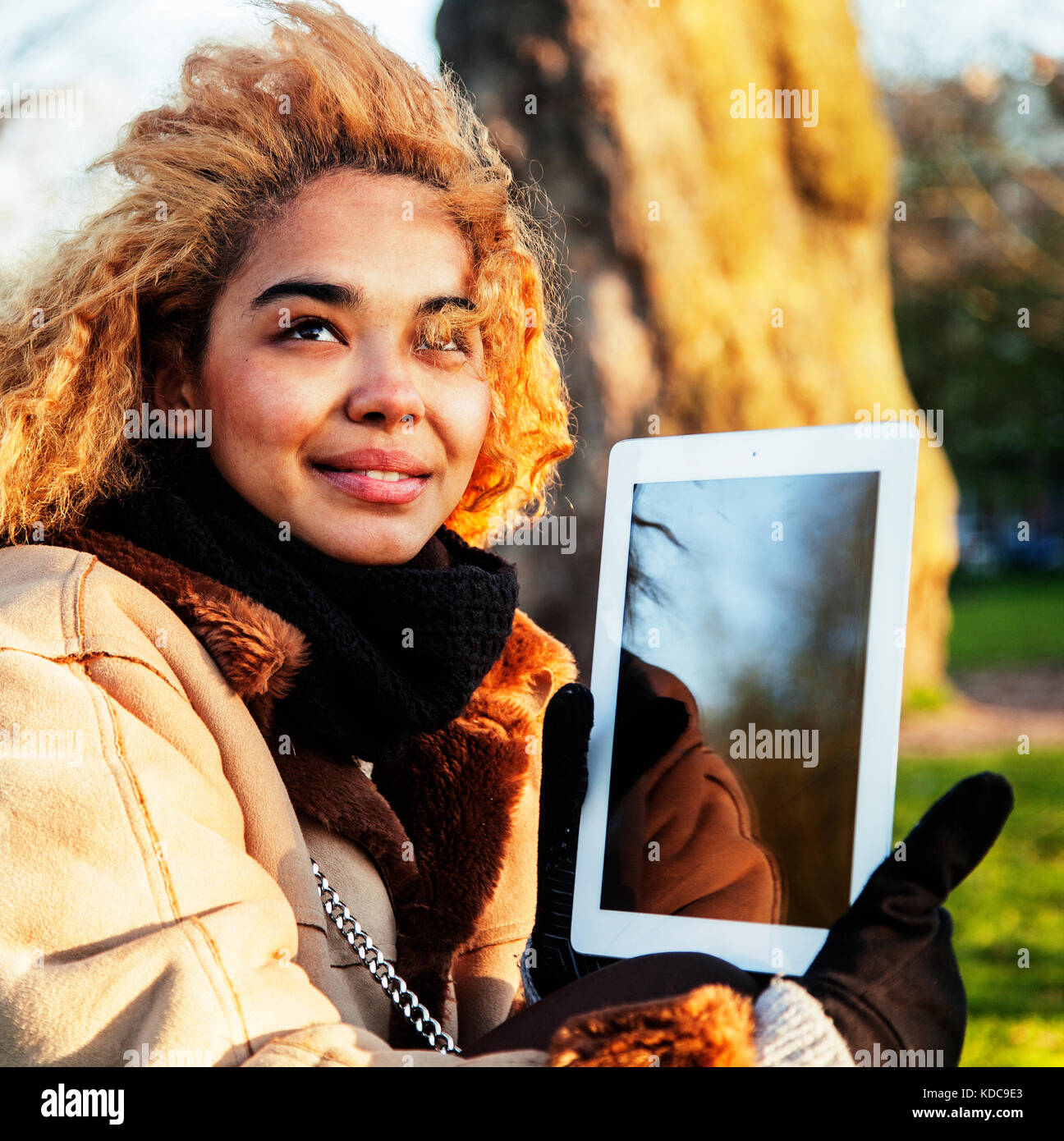 young cute blond african american girl student holding tablet an Stock ...