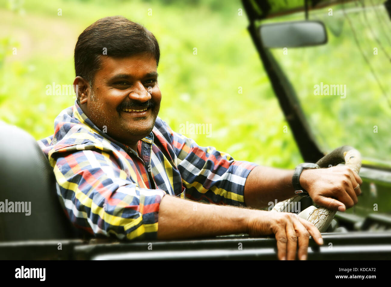 Close up view of handsome young man with stylish beard sitting on ...