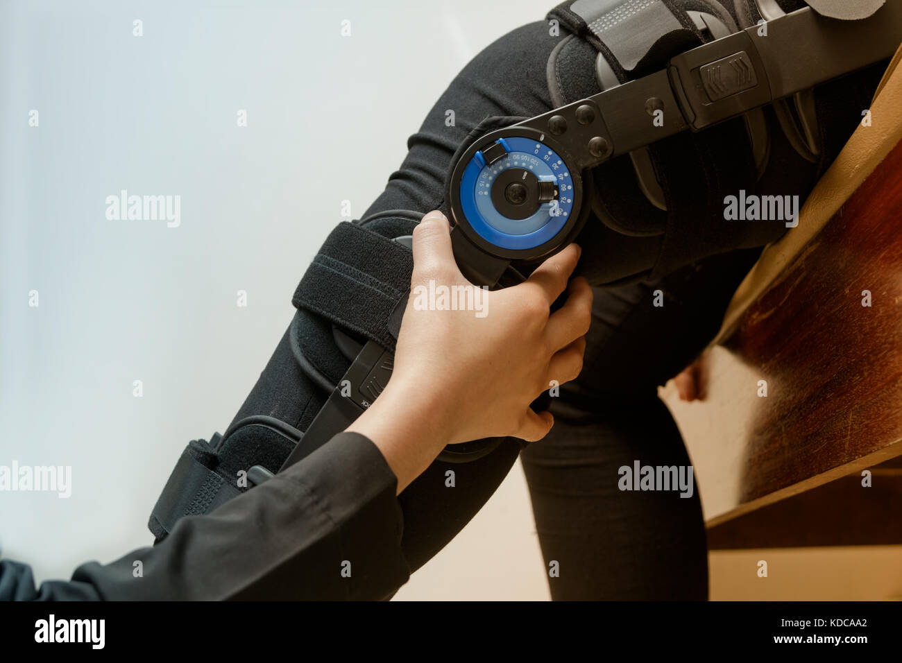 Physiotherapist adjust knee braces on patient 's leg in hospital Stock ...