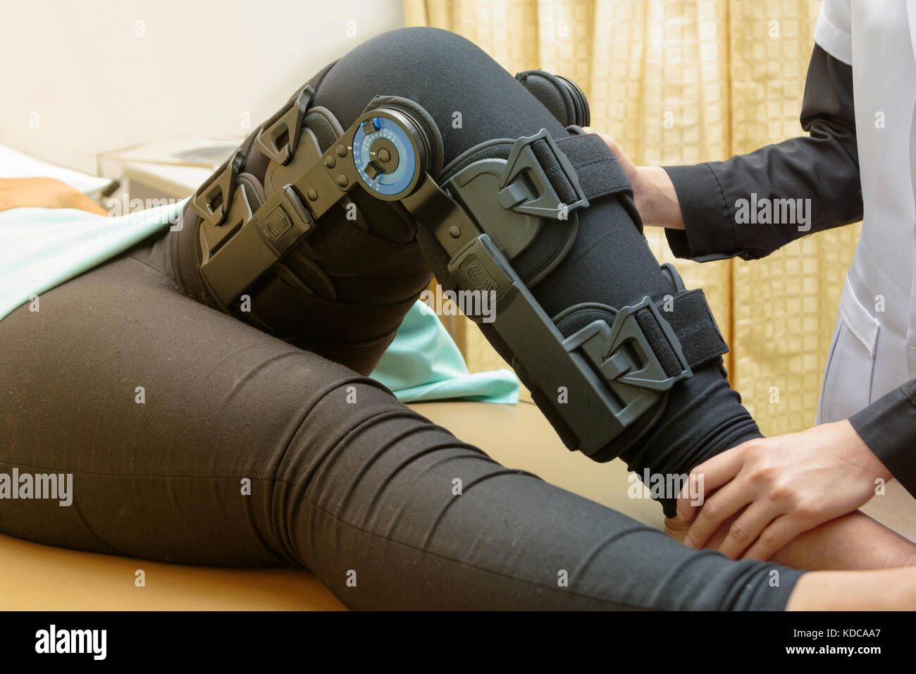 Physiotherapist do stretch exercises on patient's leg, rehabilitation ...