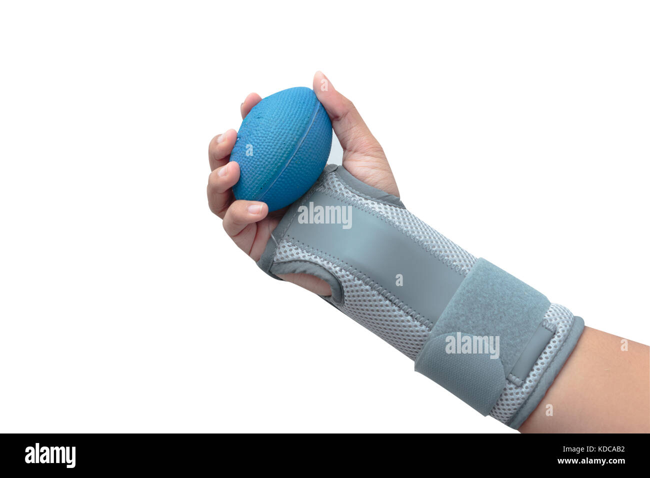 Woman's hand with wrist support squeezing a soft ball for hand exercise ...