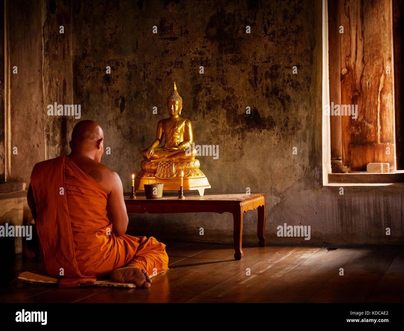 Buddhist monk pray to buddha in the temple Stock Photo - Alamy