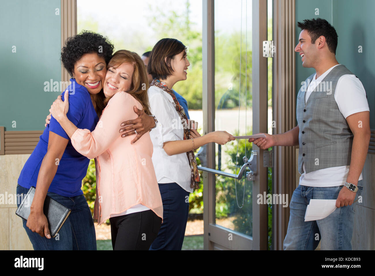 Welcome team in the lobby of a building Stock Photo - Alamy