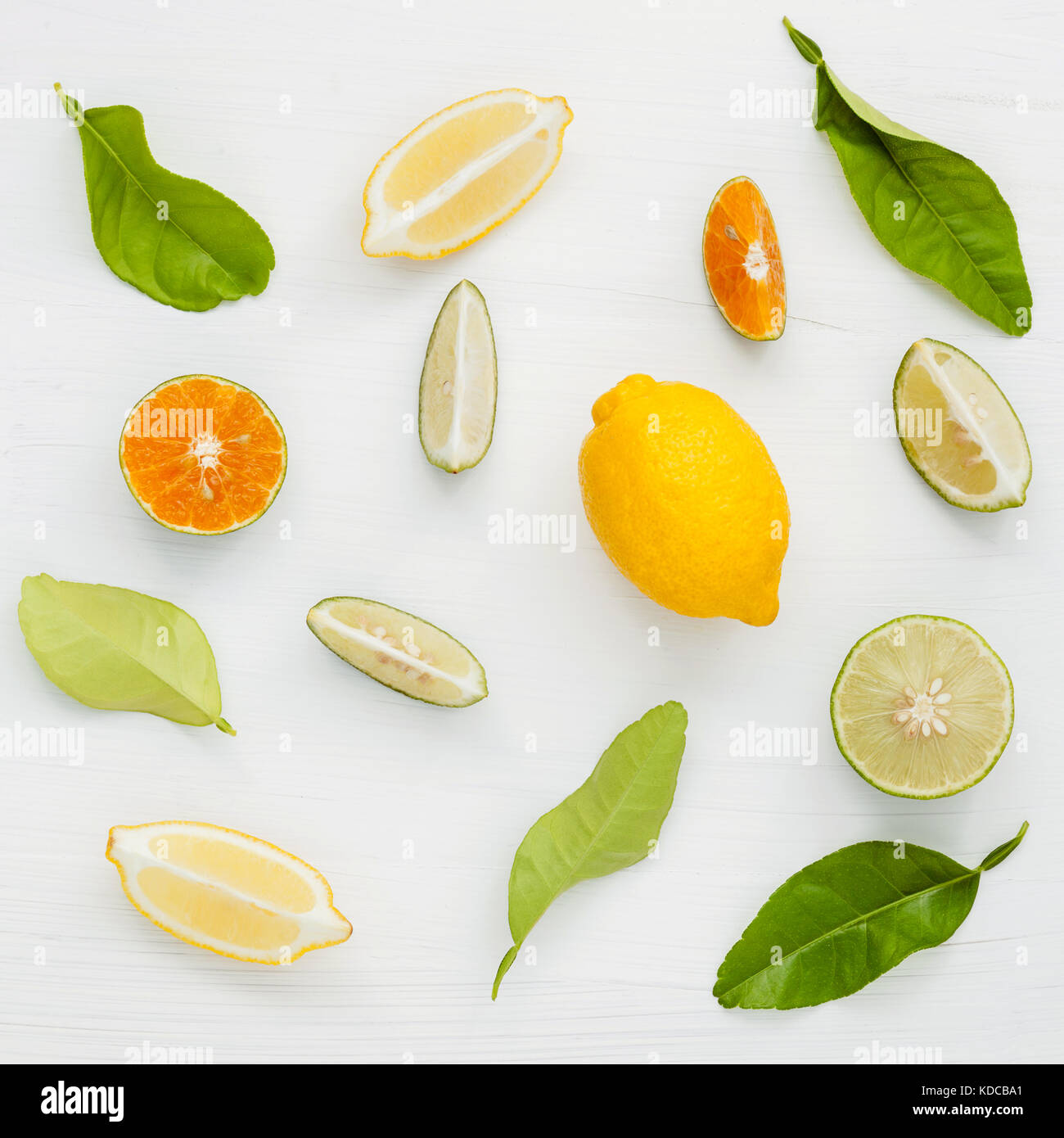Mixed fresh citrus fruits and leaves background. Fresh lemons, lemon ...