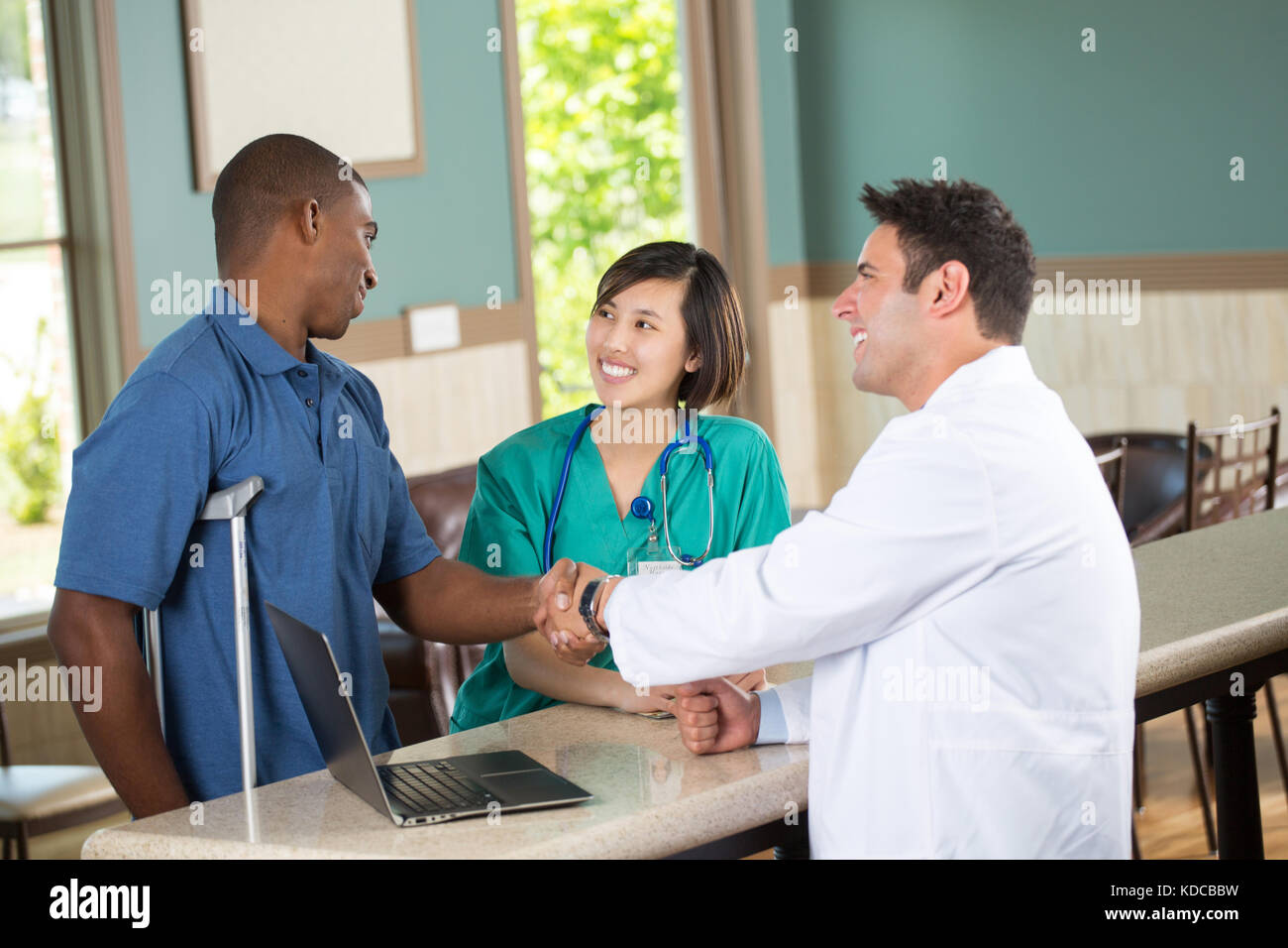 Medical team talking with a patient in the doctors office Stock Photo ...