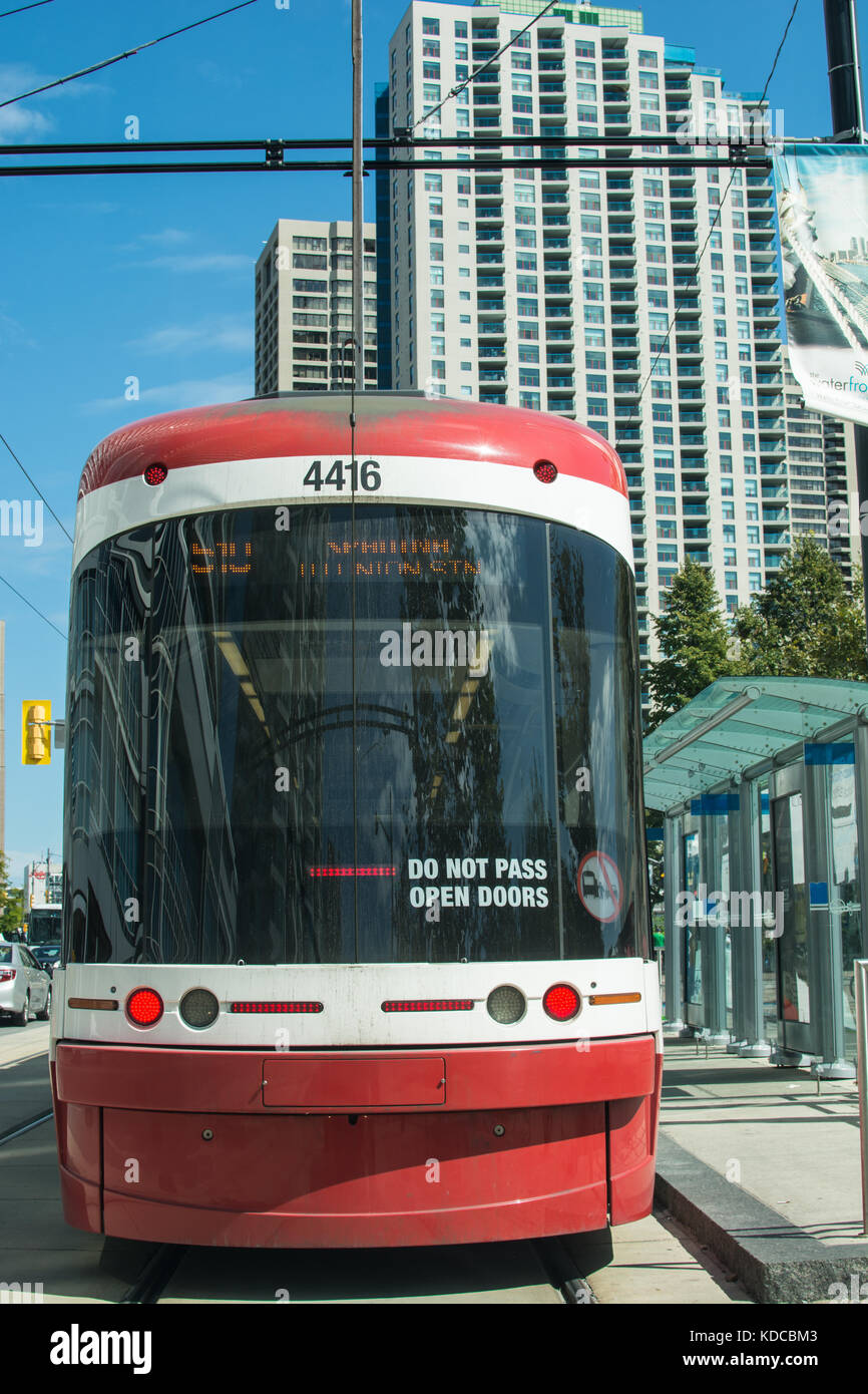 Streetcar in Toronto electric cables front window stopped bus stop ...