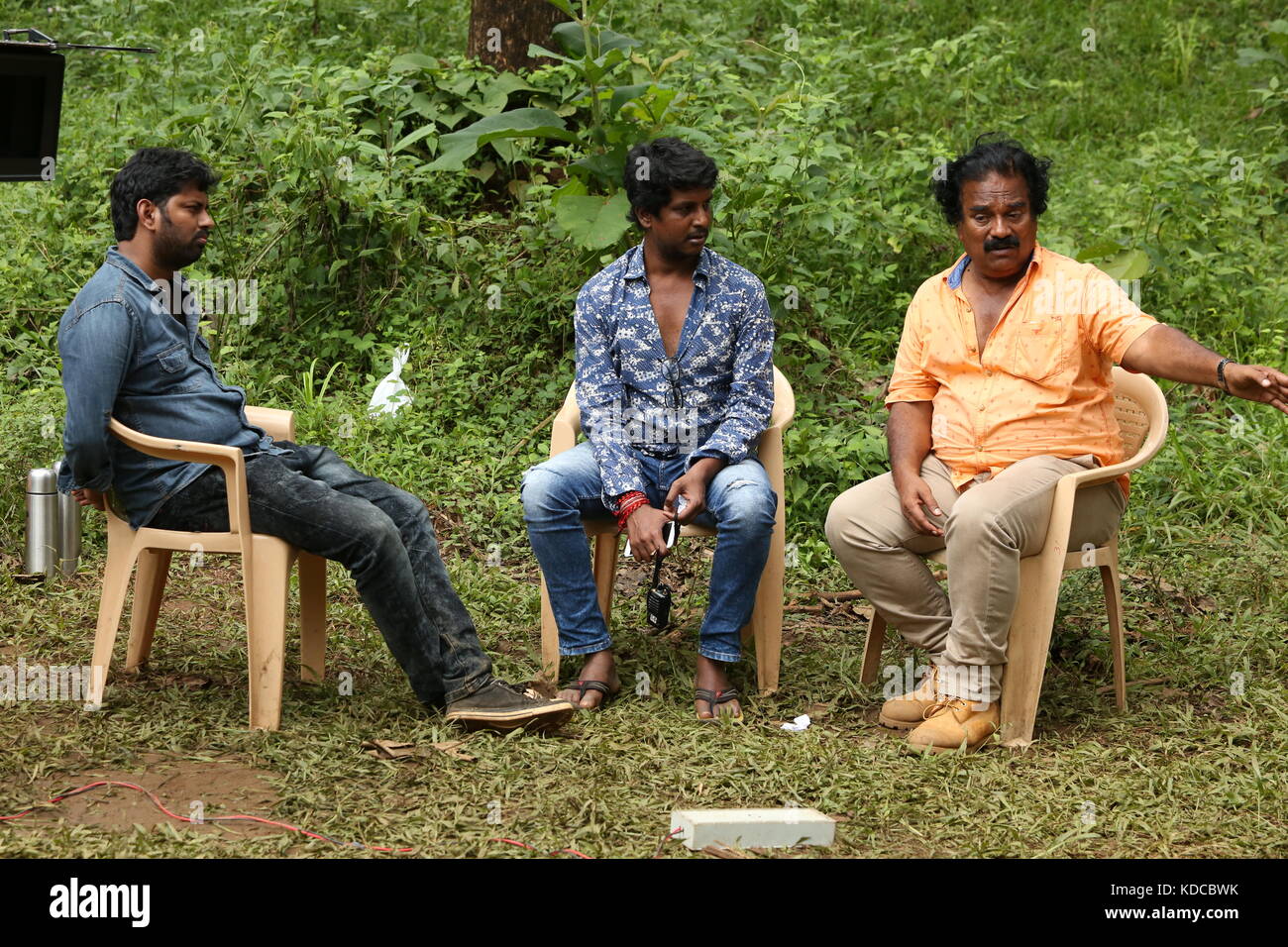 Three people siting chair at nature background, shooting spot Stock ...