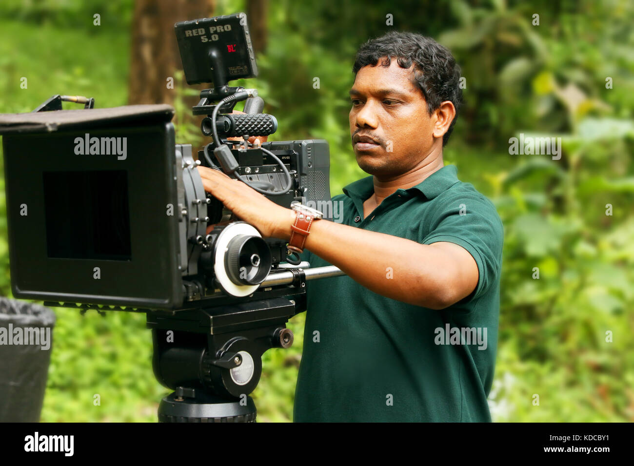 Young cameraman shooting at nature background Stock Photo - Alamy