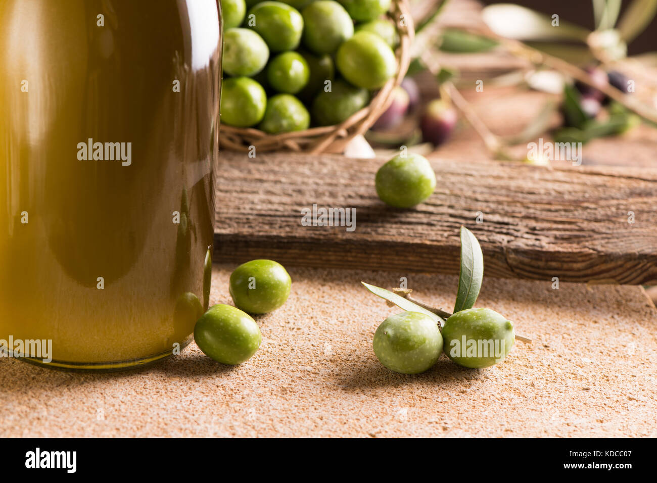 Olive Oil And Olive Sprig With Green Olives Stock Photo - Alamy