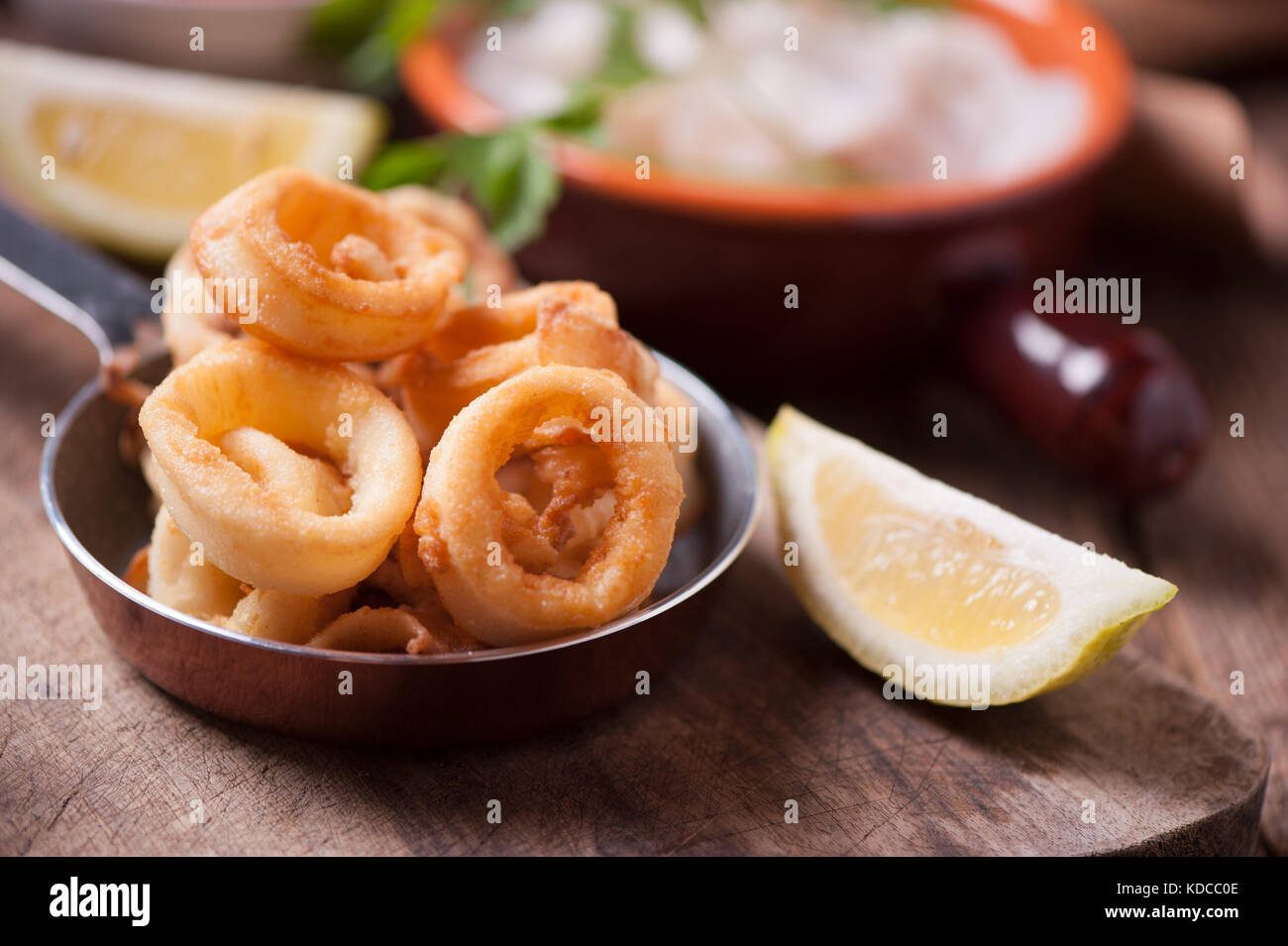 Fried calamari squid on wooden table Stock Photo - Alamy