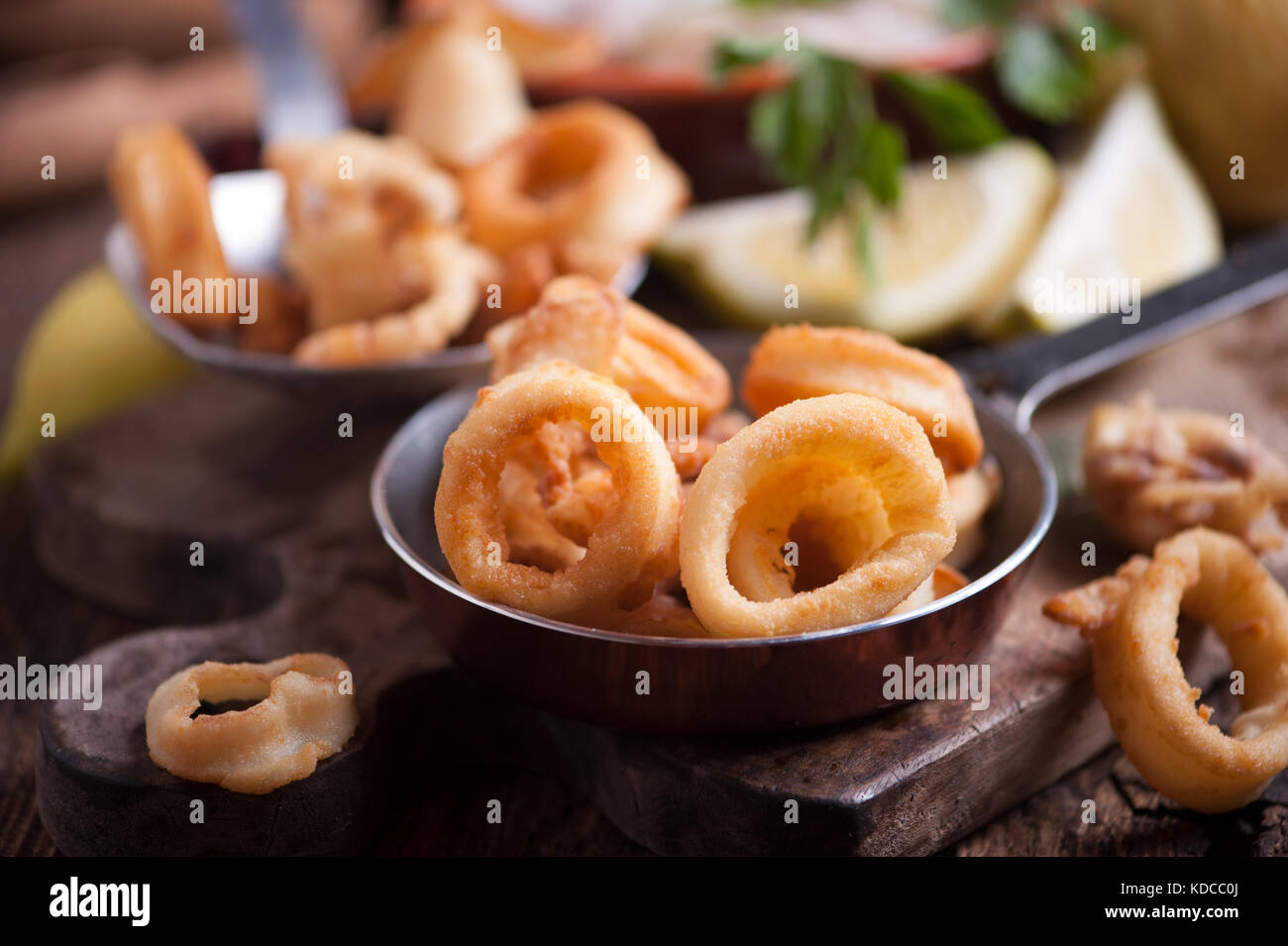 Fried calamari squid on wooden table Stock Photo - Alamy