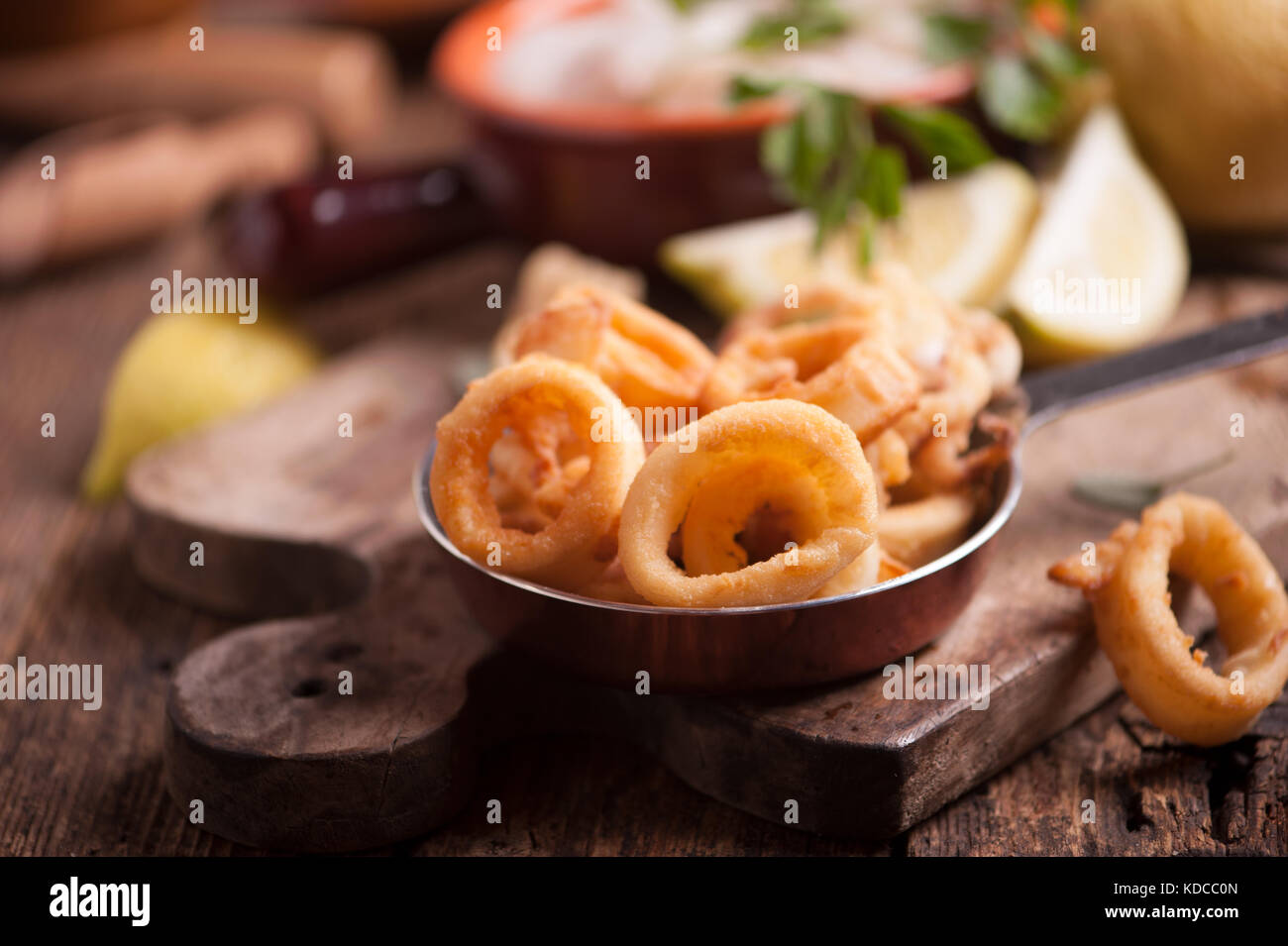 Fried calamari squid on wooden table Stock Photo - Alamy