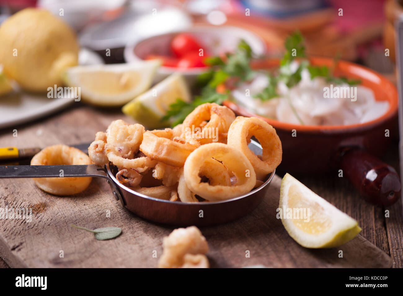 Fried calamari squid on wooden table Stock Photo - Alamy