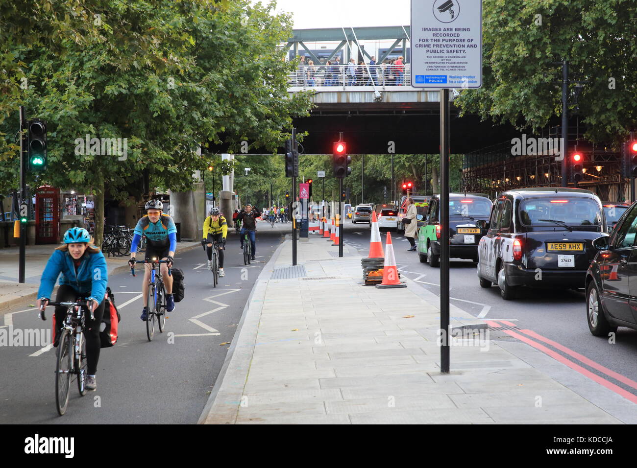 Cyclists in a segregated lane, and traffic on the Embankment in London ...