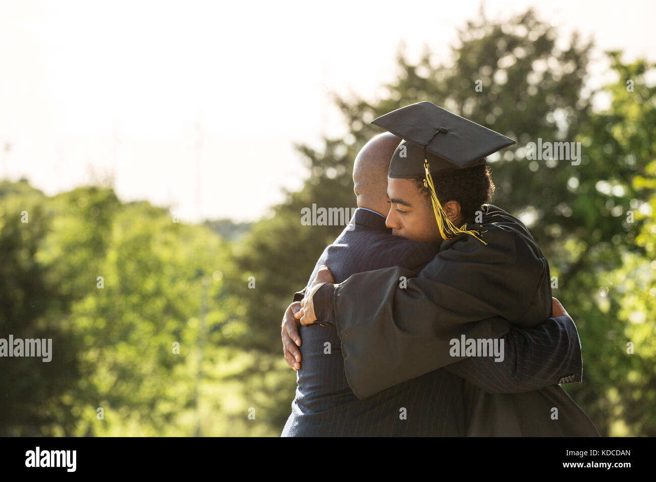 Father hugging his son on his graduation day Stock Photo - Alamy