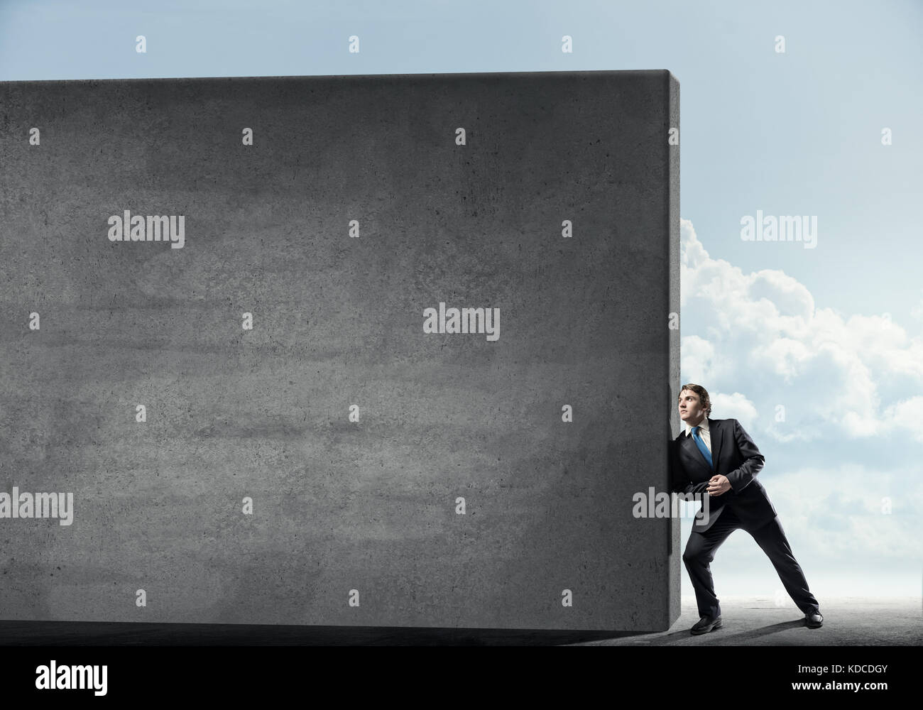 Businessman push wall Stock Photo - Alamy