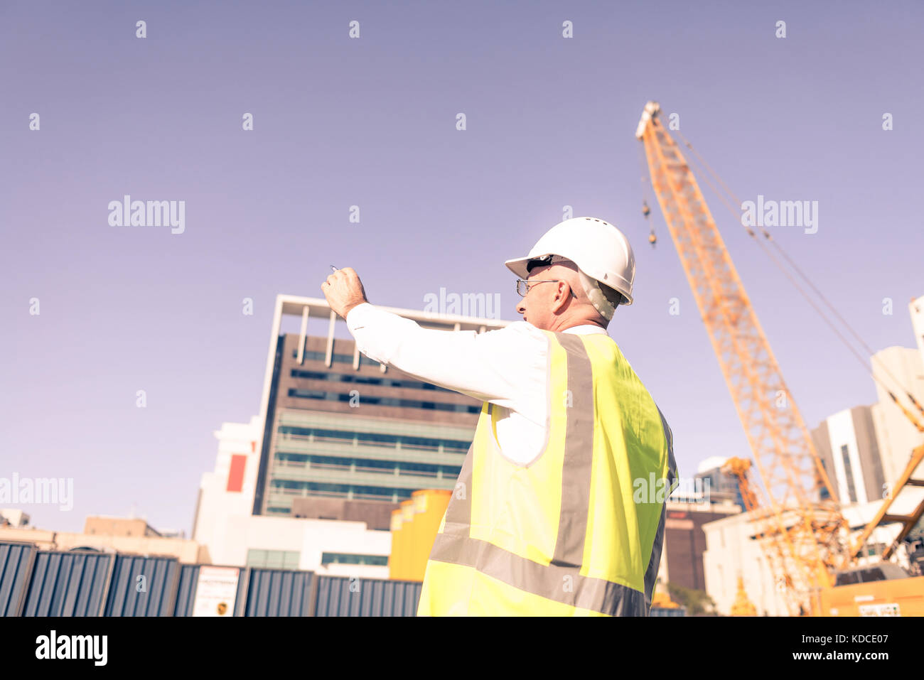 Senior foreman in glasses doing his job at building area on sunn Stock ...