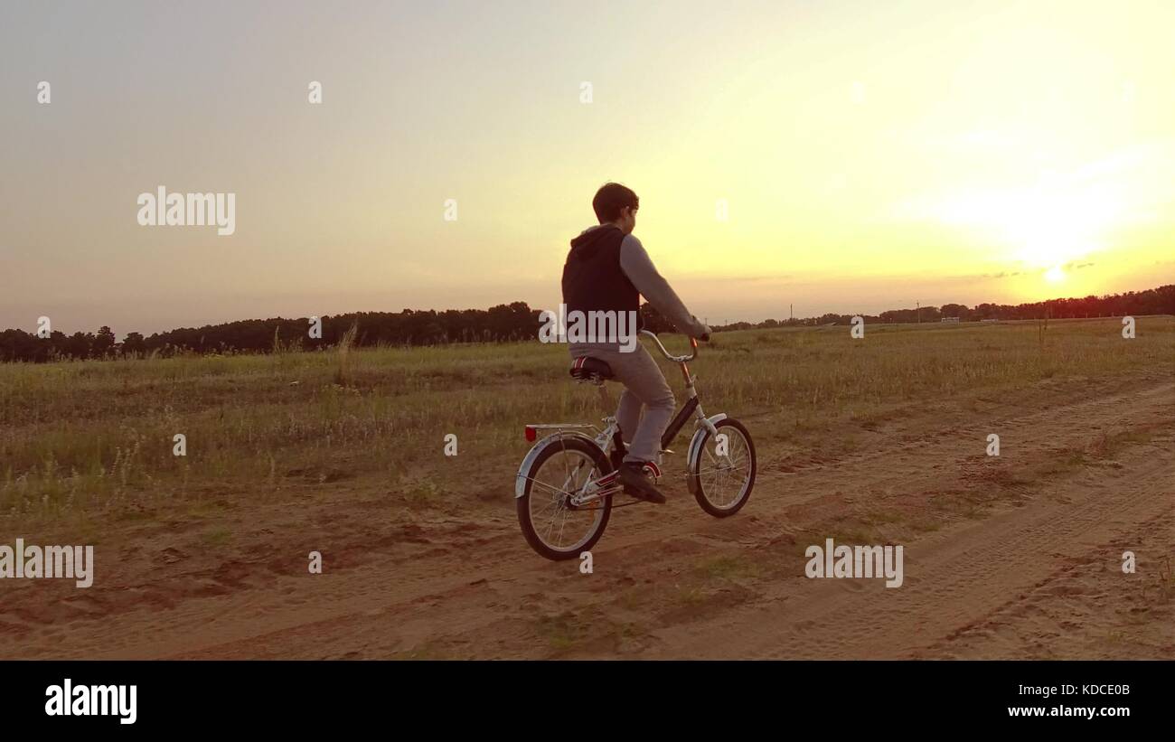 Boy teenager riding a bicycle. Boy teenager riding a bicycle goes to ...