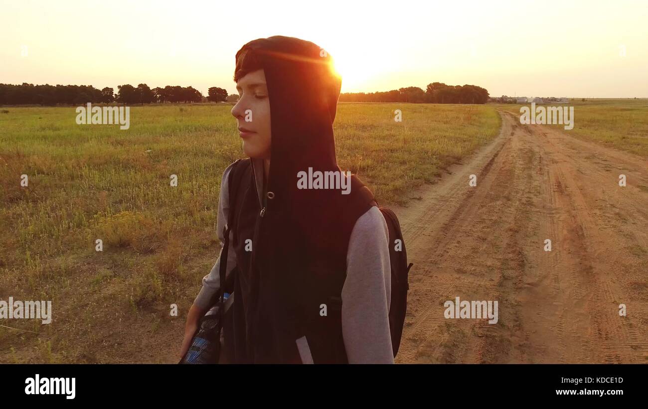 Boy teen traveling. Boy teenage tramp walking along the road in hood ...