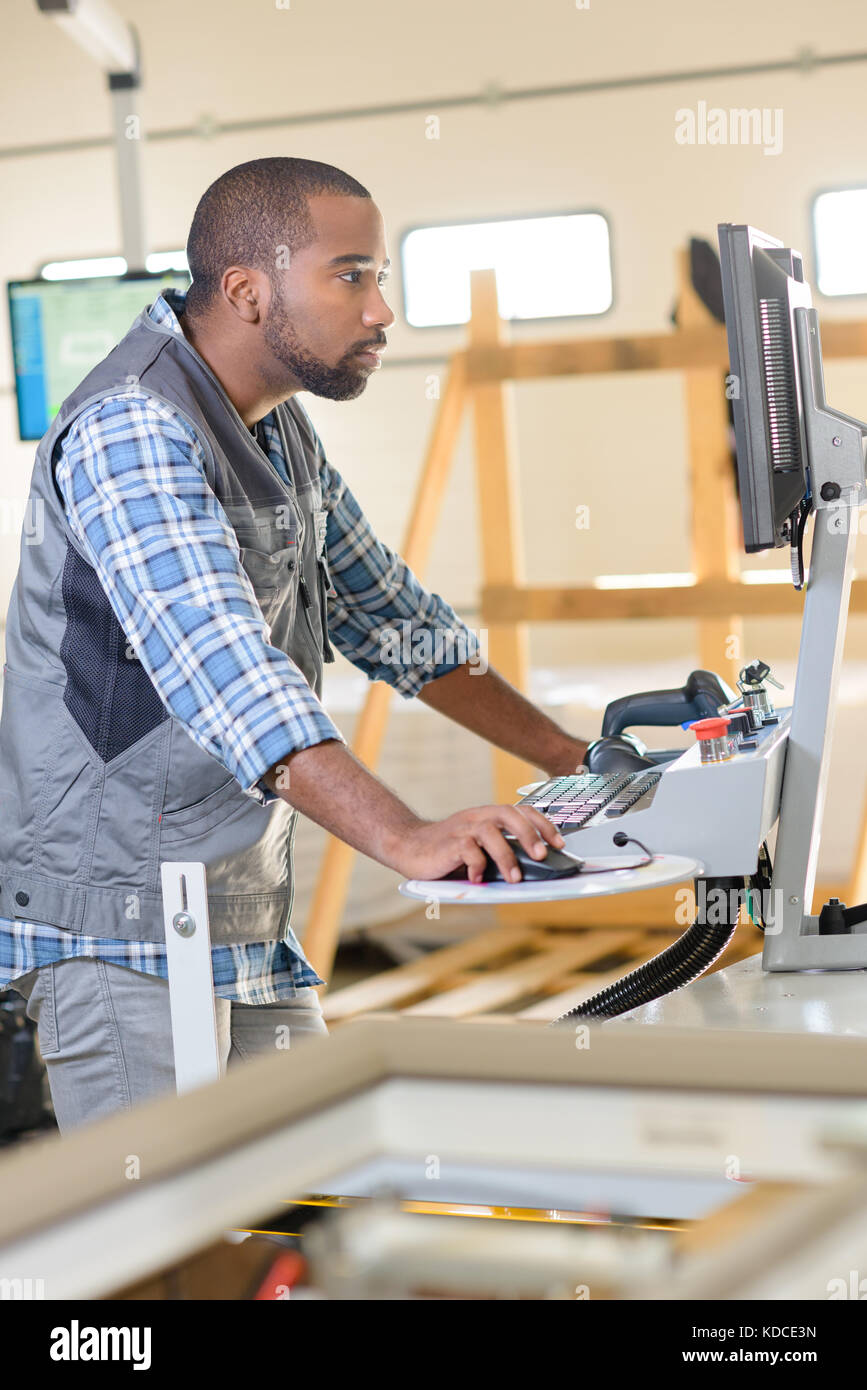 Tradesman using computer Stock Photo - Alamy