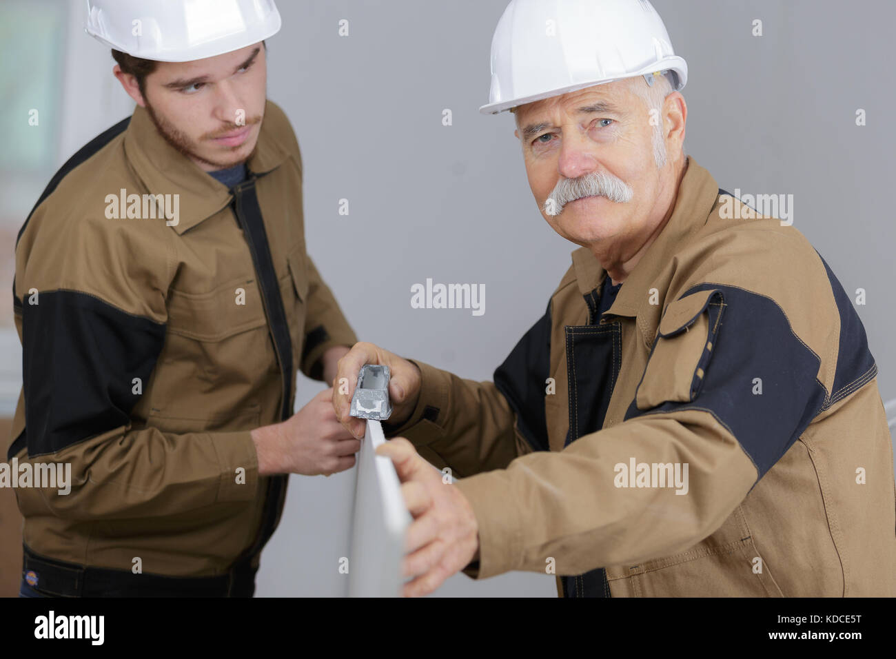 senior foreman with a younger worker Stock Photo - Alamy