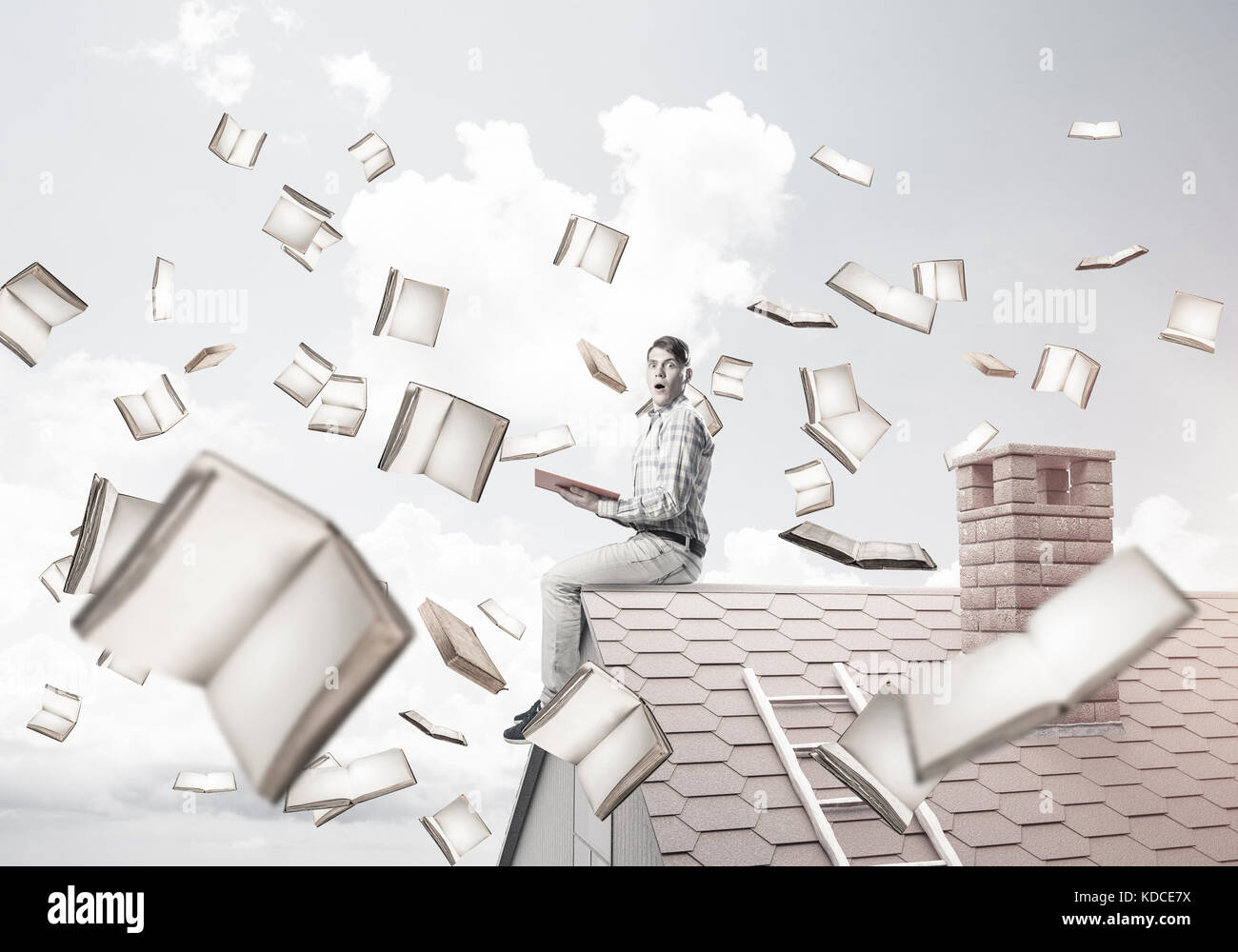Man reading book and many of them flying in air Stock Photo - Alamy