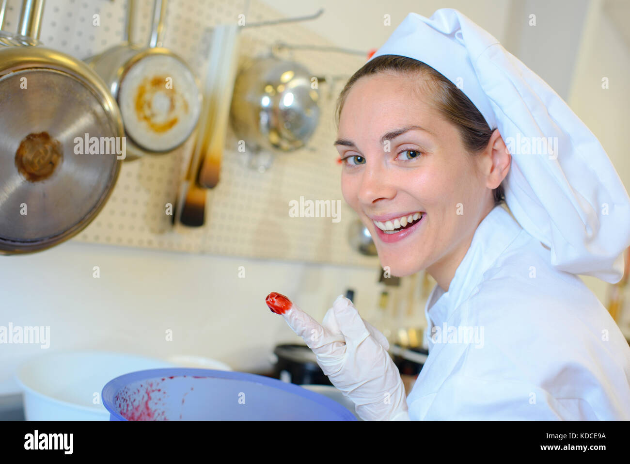 Laughing chef with food on finger Stock Photo - Alamy