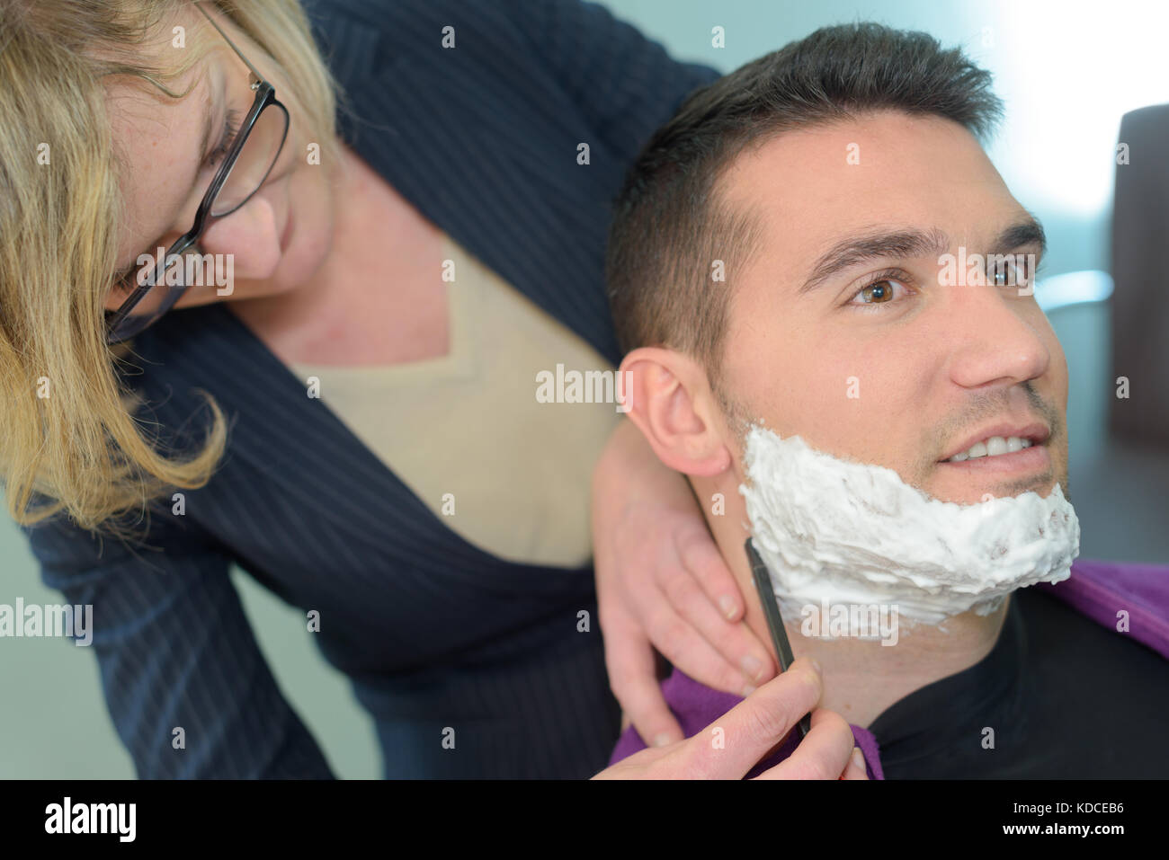 shaving a mans beard Stock Photo - Alamy