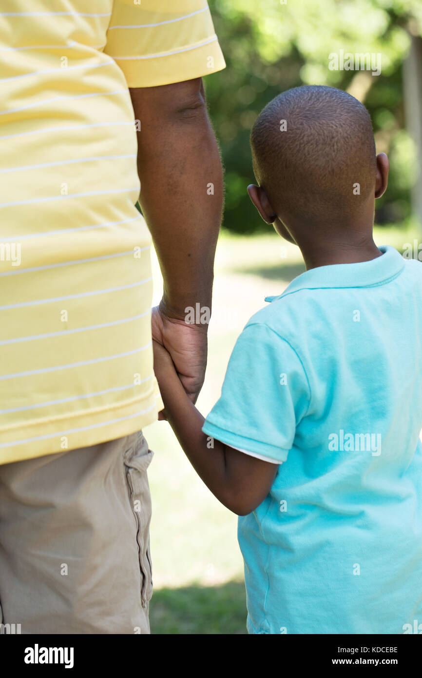 African American loving father guiding his son Stock Photo - Alamy