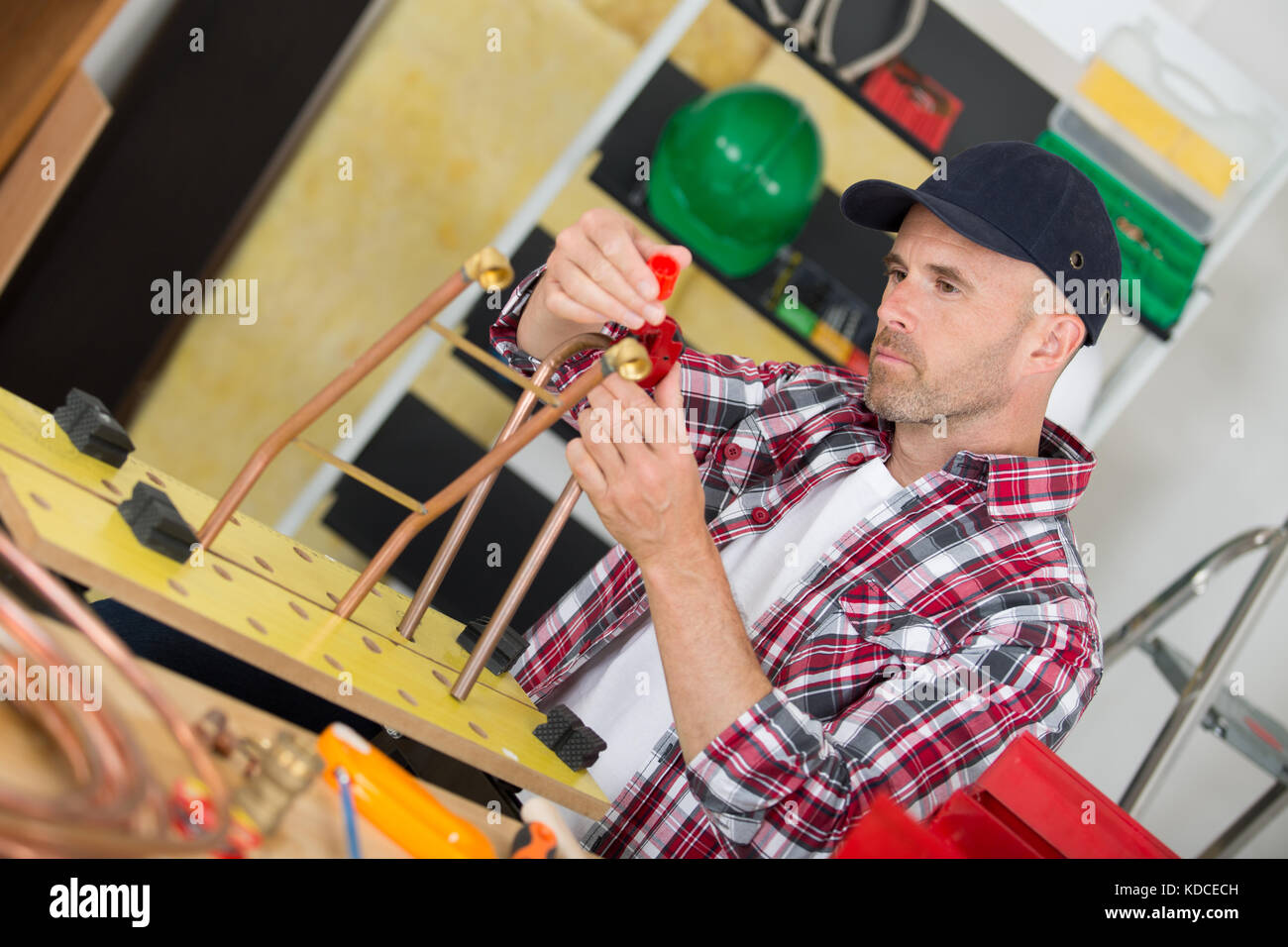 Man connecting copper pipes Stock Photo - Alamy