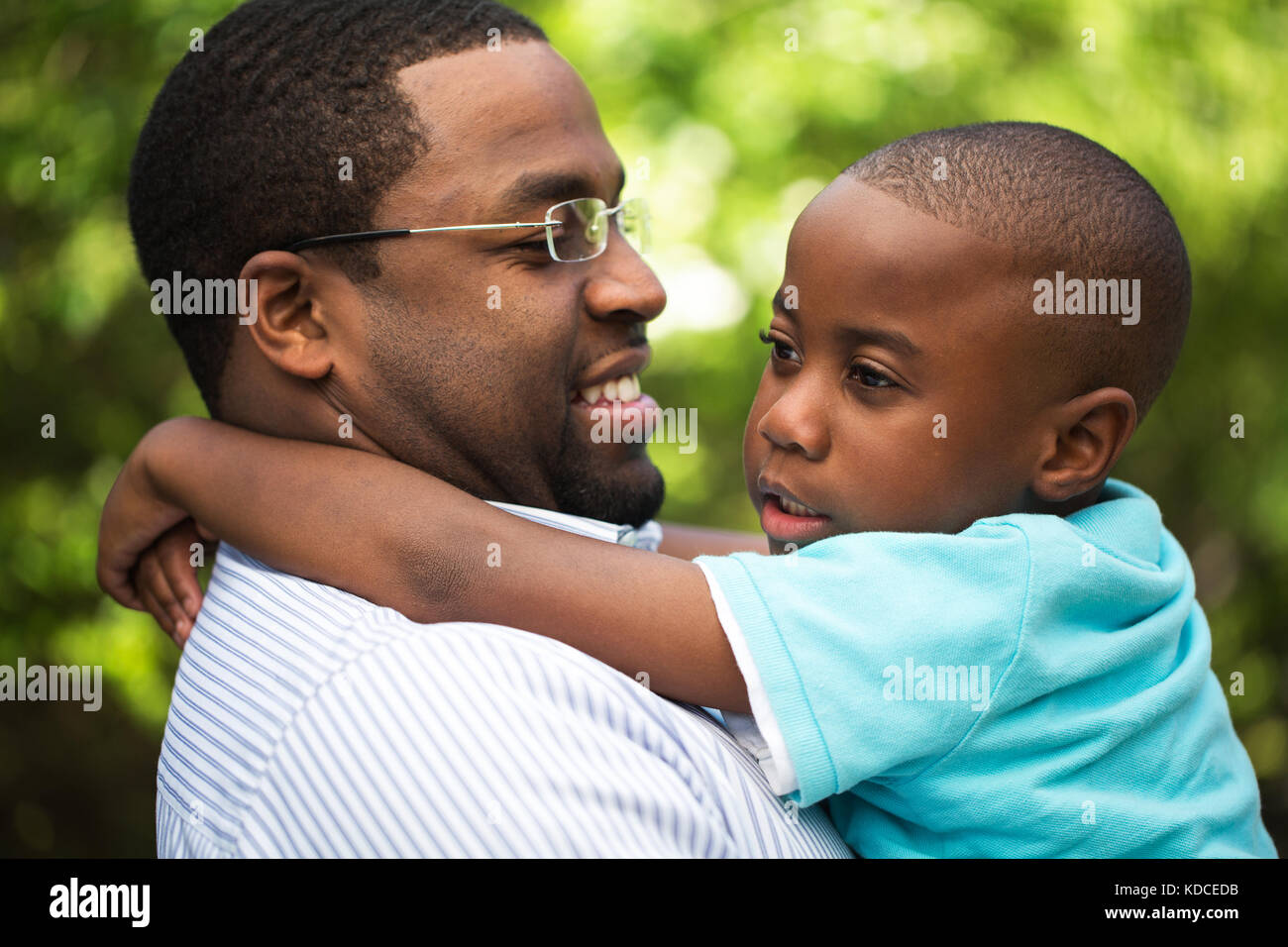 Father hugging his his son Stock Photo - Alamy