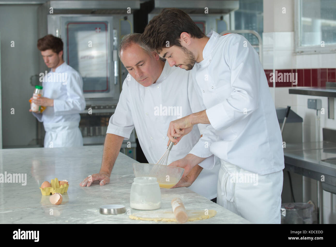 apprentice chef preparing food in the kitchen at the restaurant Stock ...