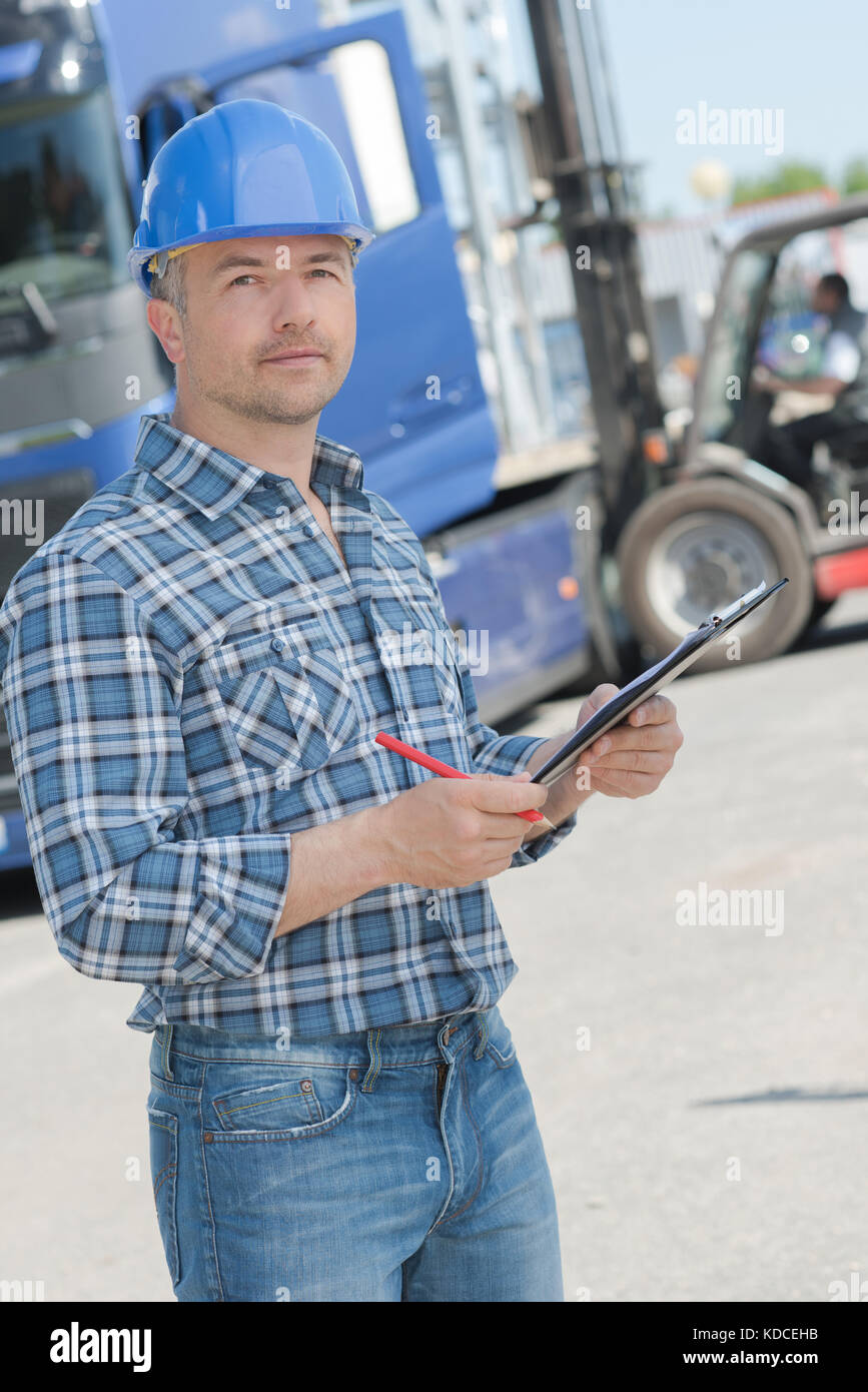 Portrait of worker with clipboard Stock Photo - Alamy