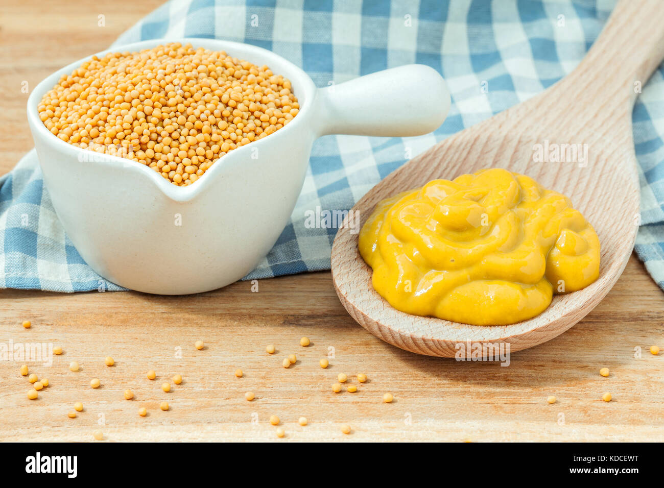 Composition of mustard and mustard seeds on wooden background Stock ...