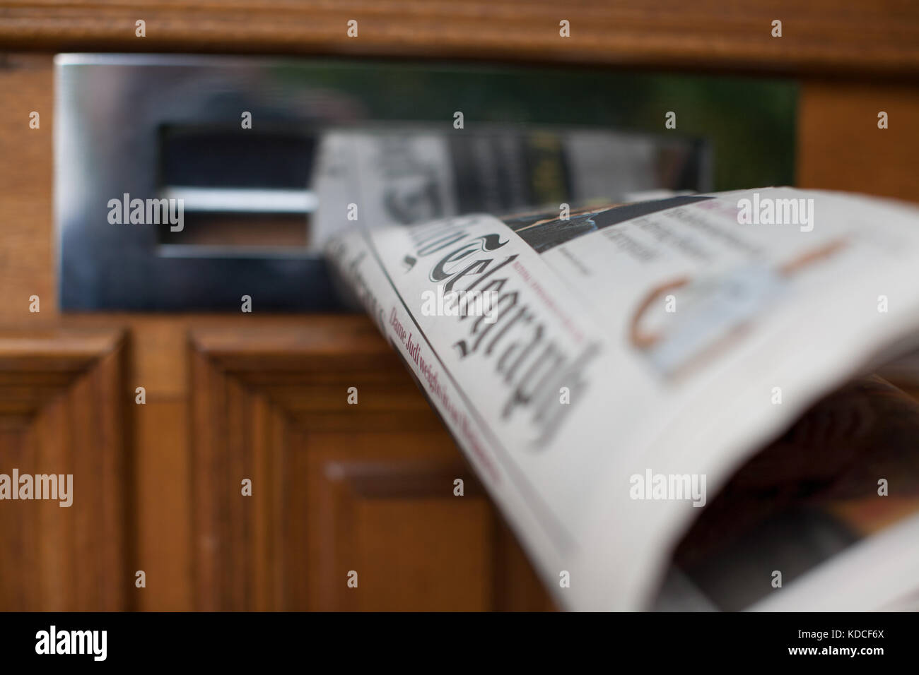 Newspaper through letterbox hi-res stock photography and images - Alamy