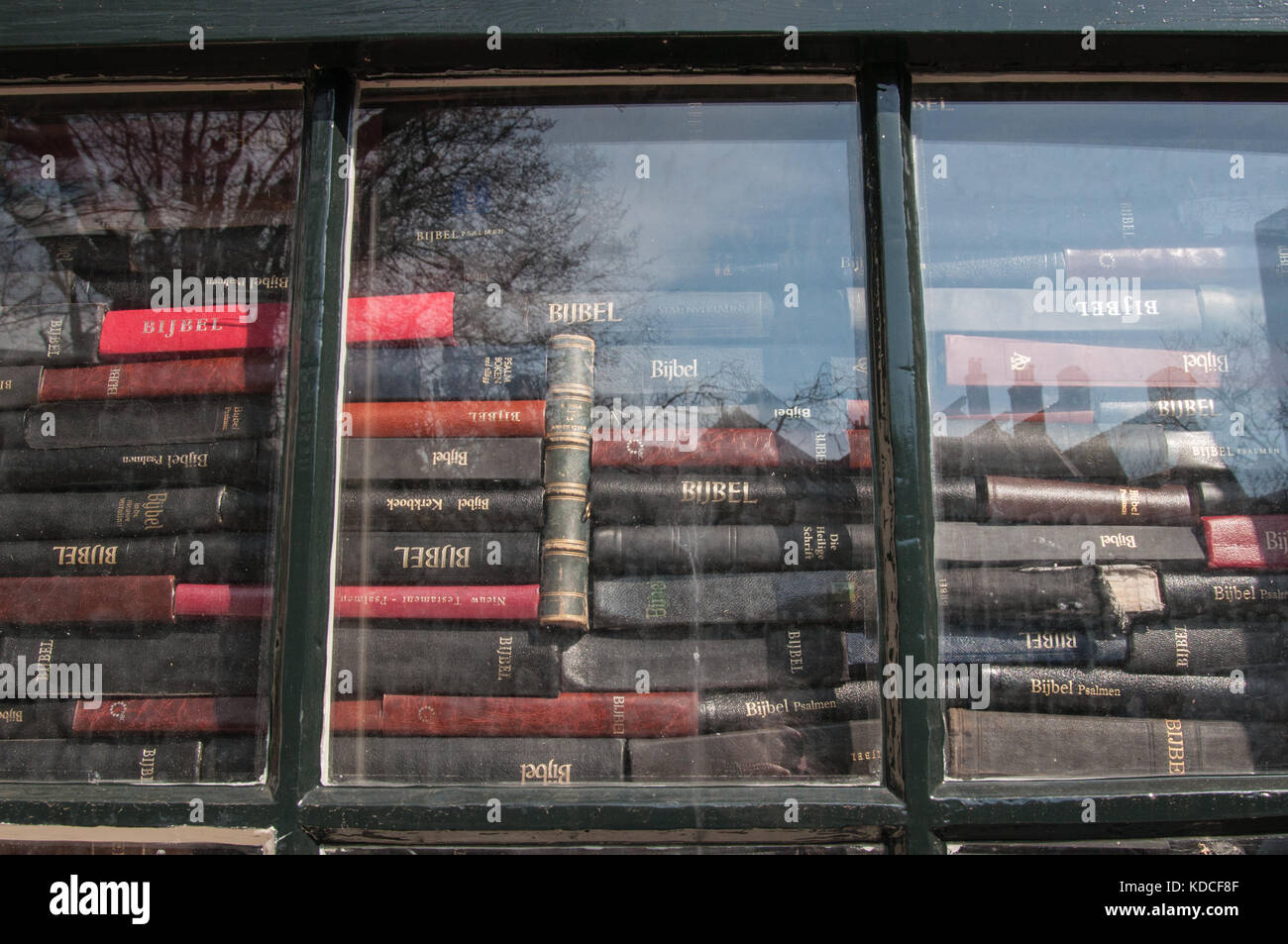 Stacks of Dutch bibles on display in the window of a church in ...