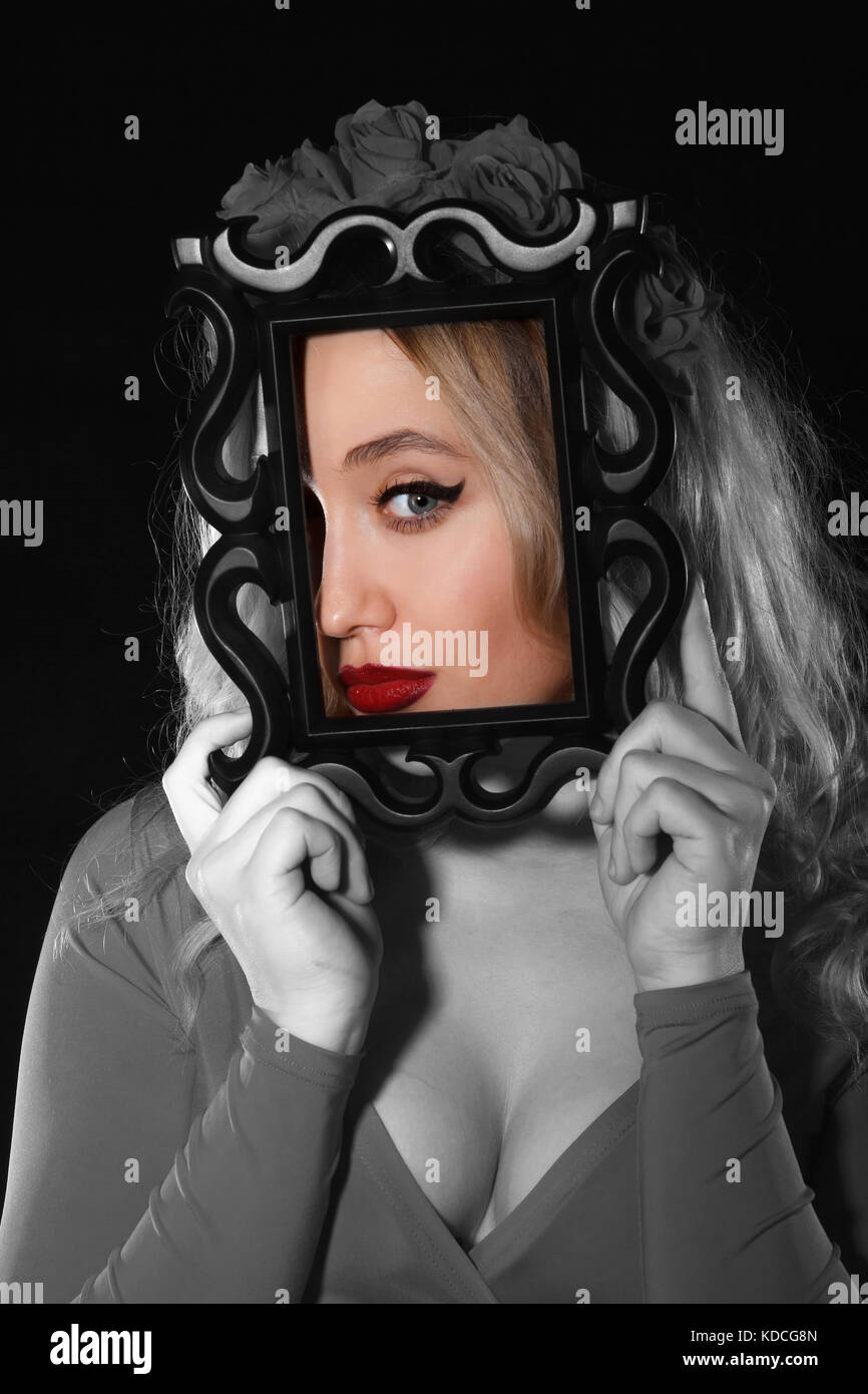 Beautiful woman holding picture frame hi-res stock photography and ...