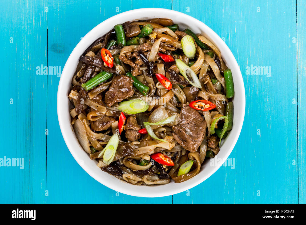 Chinese Style Wok Stir Fried Beef With Mushrooms and Noodles On A Blue ...